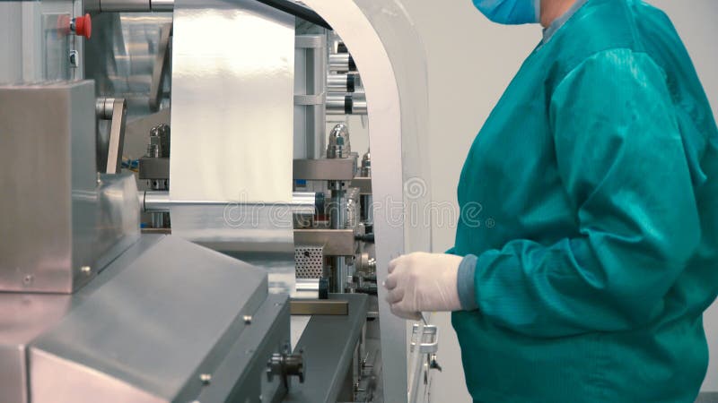 Worker in Mask and Protective Uniform Control the Process of Sorting ...