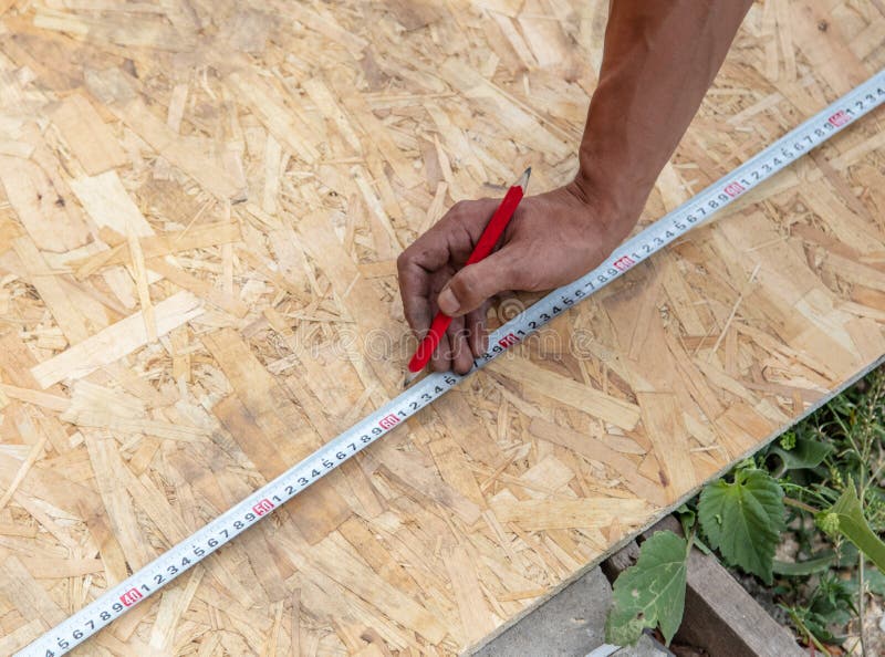 Worker Measures the Board at a Construction Site Stock Image - Image of ...