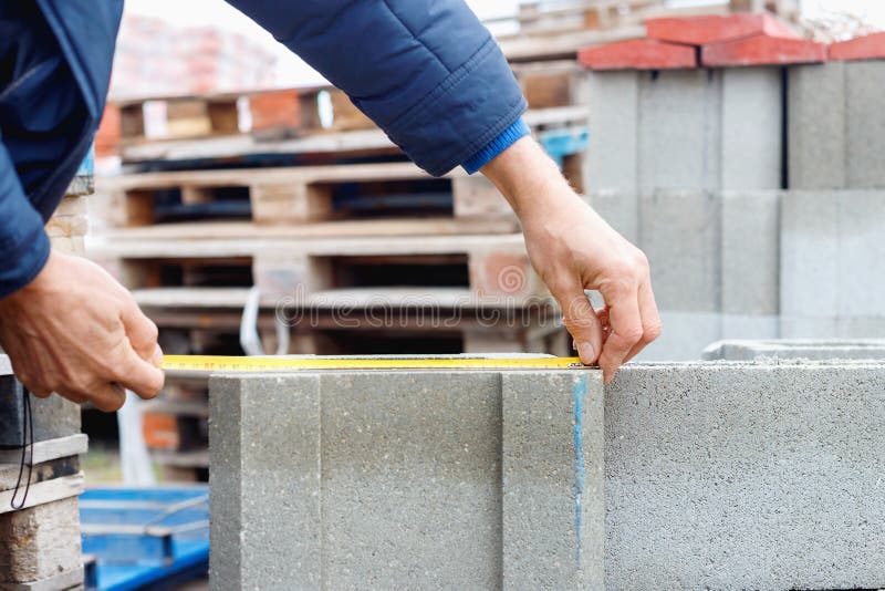 Worker Measures Cement Building Blocks on the Warehouse Stock Image ...