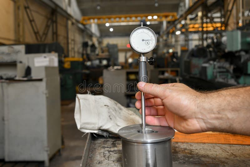 The Worker Measures the Inner Diameter of the Hole with a Bore Gauge ...
