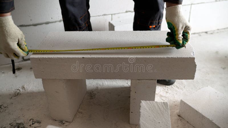 A Worker Measures the Length of a Building Block for an Internal ...