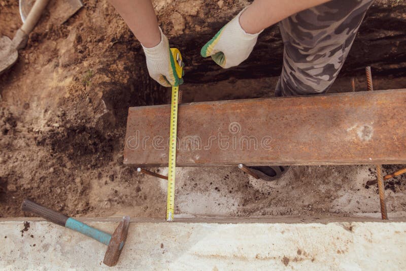 The Worker Measures the Length at the Construction Site Stock Image ...