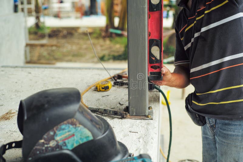 Worker Measures the Level of Perpendicular during Installing the Steel ...