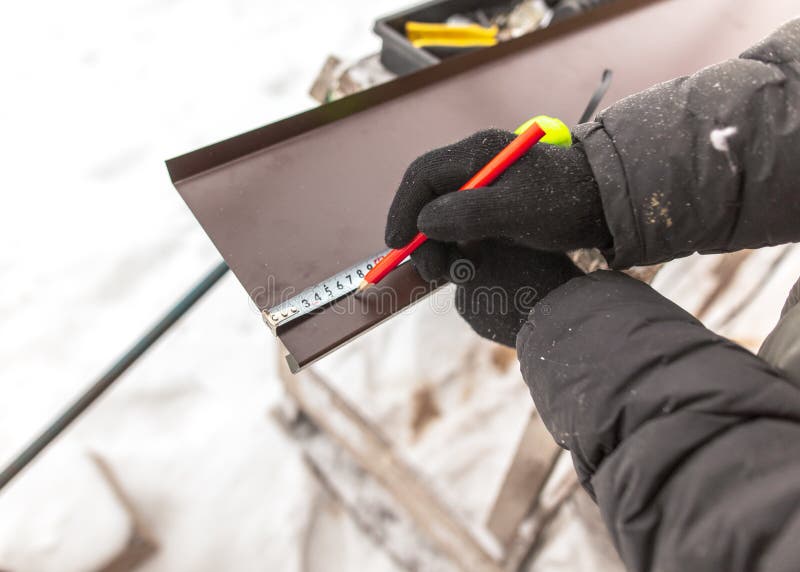 A Worker Measures Metal at a Construction Site with a Meter Stock Photo ...