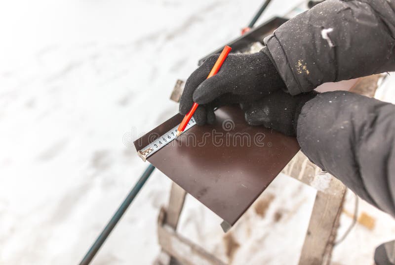 A Worker Measures Metal at a Construction Site with a Meter Stock Image ...