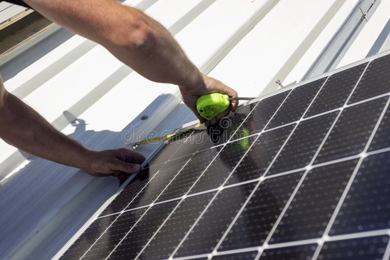 A Worker Measures Solar Panels with a Meter To Install Them on the ...