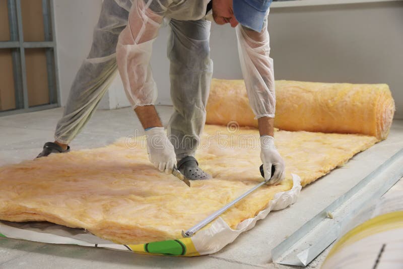 Worker Measuring and Cutting Insulation Material Indoors Stock Image ...