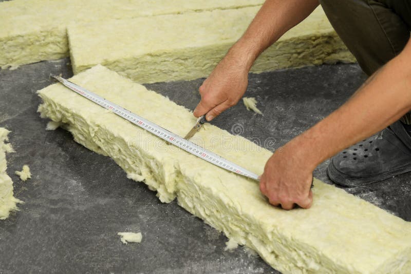 Worker Measuring and Cutting Insulation Material Indoors, Closeup Stock ...