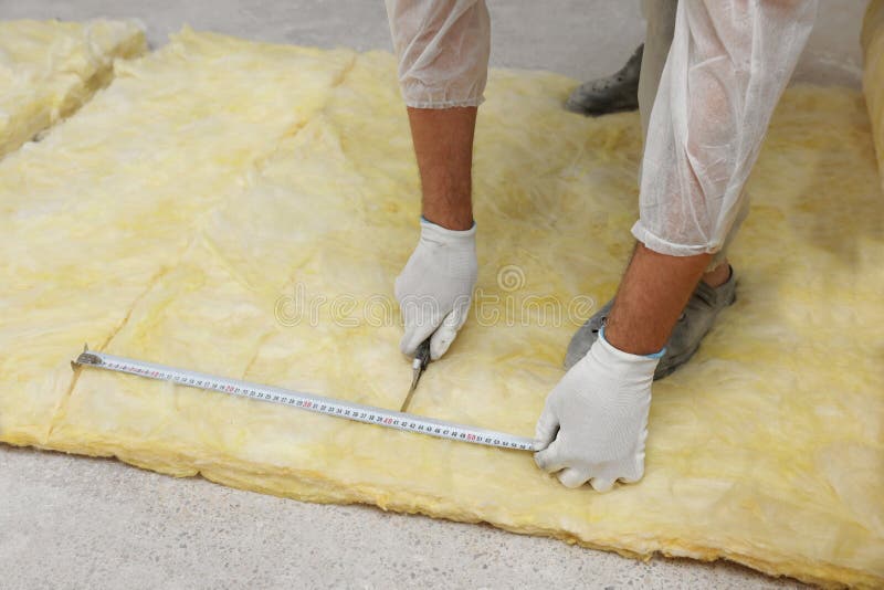Worker Measuring and Cutting Insulation Material Indoors, Closeup Stock ...