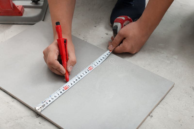 Worker Measuring and Marking Ceramic Tile on Floor, Closeup Stock Photo ...