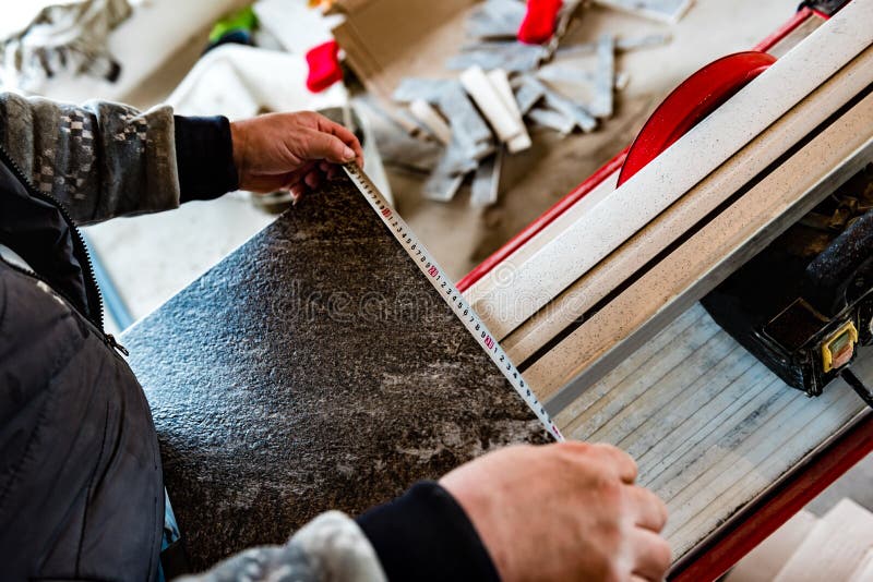 Worker Measuring Tile for Cutting on Tile Cutter Machine. Stock Photo ...