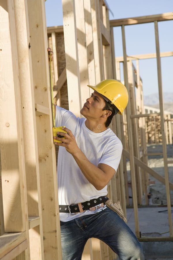 Worker Measuring Timber at Construction Site Stock Image - Image of ...