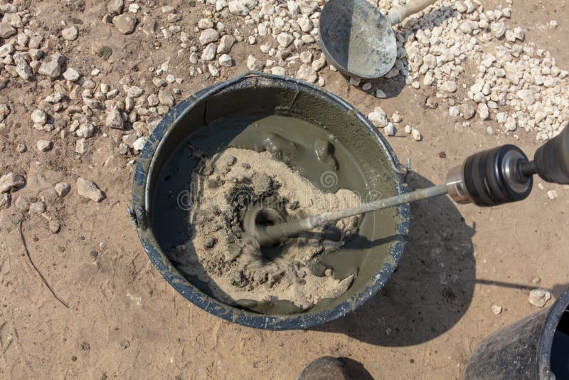 The Worker Mixes the Concrete Mixture at the Construction Site Stock ...