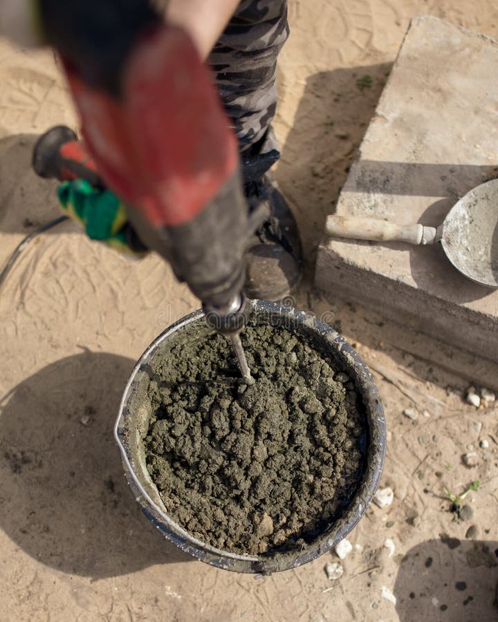 The Worker Mixes the Concrete Mixture at the Construction Site Stock ...