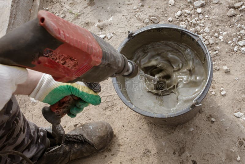 The Worker Mixes the Concrete Mixture at the Construction Site Stock ...