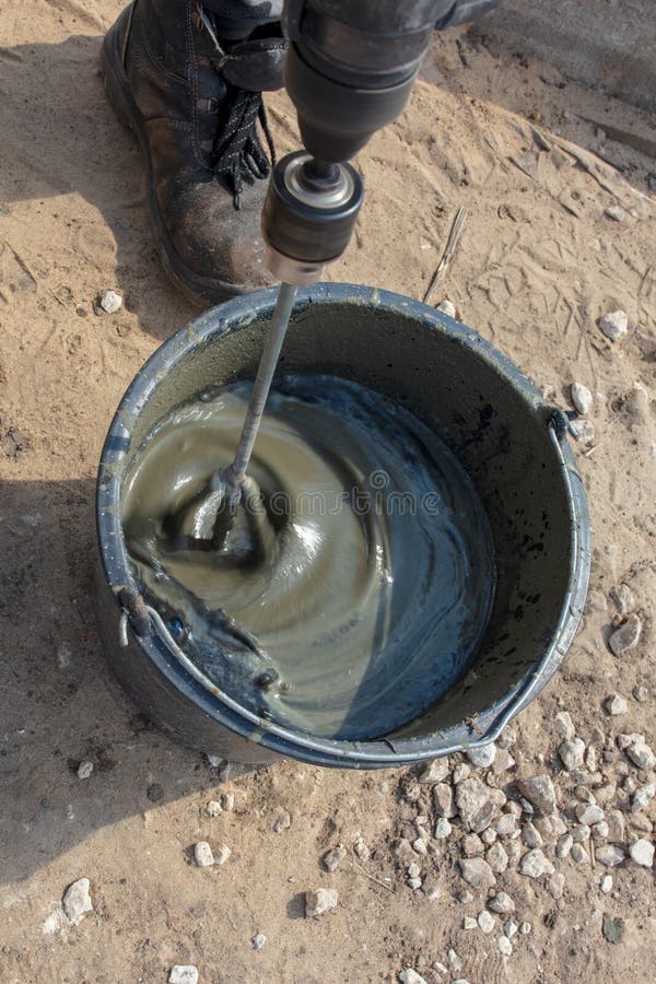 The Worker Mixes the Concrete Mixture at the Construction Site Stock ...