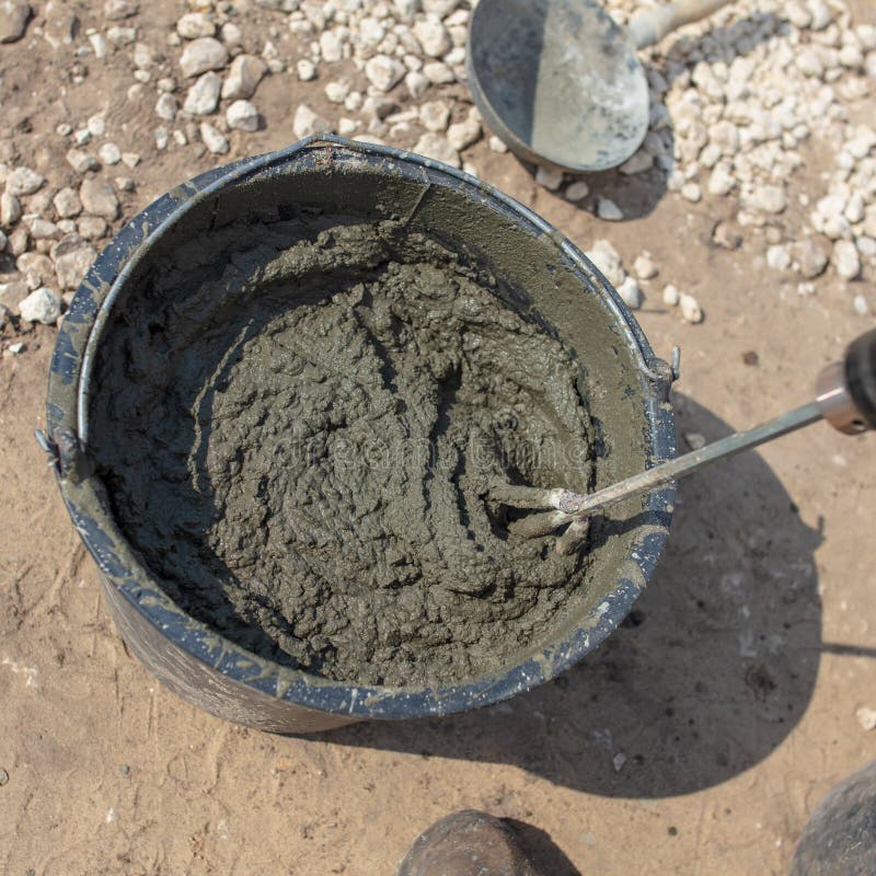 The Worker Mixes the Concrete Mixture at the Construction Site Stock ...