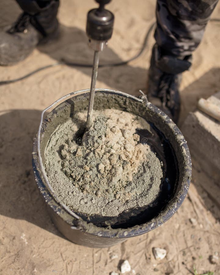 The Worker Mixes the Concrete Mixture at the Construction Site Stock ...