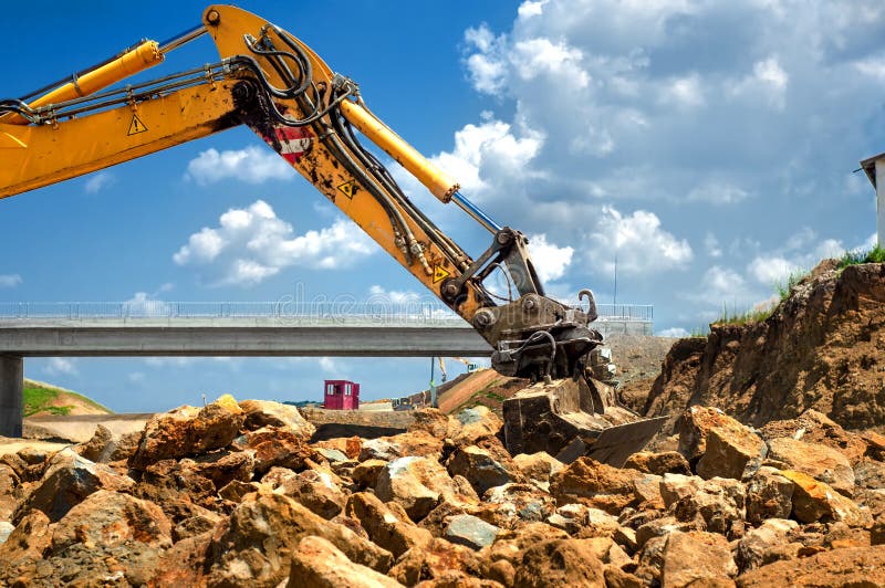 Worker Moving Rocks with Excavator on Construction Site Stock Photo ...