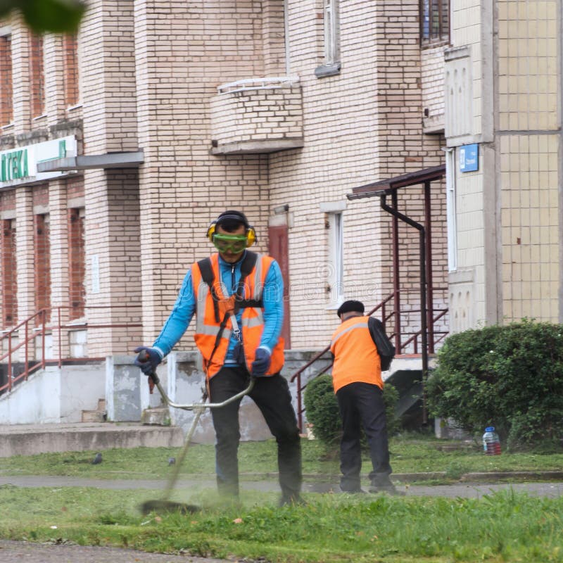 Worker Mowing Grass on the Lawn. Editorial Image - Image of lawn, mower ...