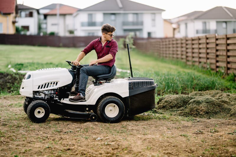 Worker Mowing Lawn and Cutting Grass Using Powerful Mower Stock Photo ...