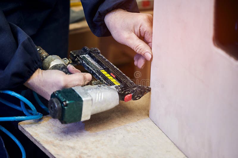 Worker with Nailing Gun in a Workshop Stock Photo - Image of people ...