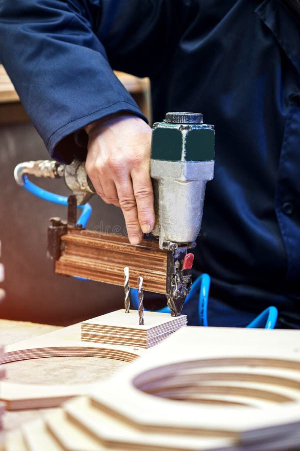 Worker with Nailing Gun in a Workshop Stock Photo - Image of front ...