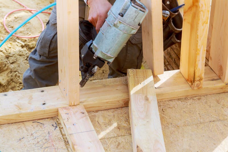 Worker Nailing Timber with Air Nail Gun Stock Photo - Image of ...