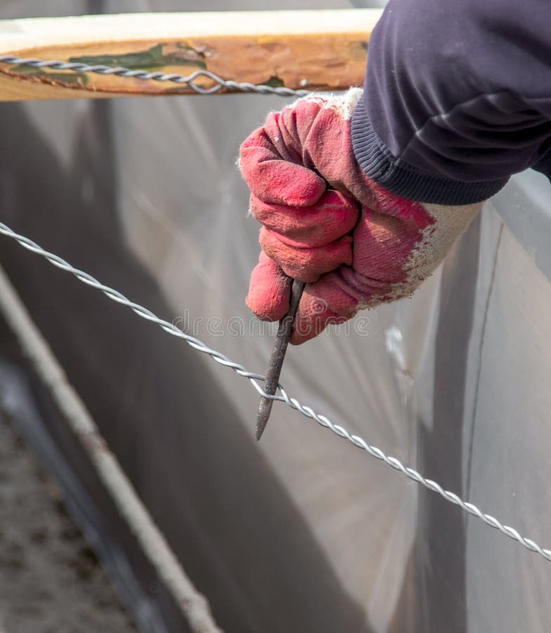 Worker Nails a Wire at a Construction Site at Home Stock Image - Image ...