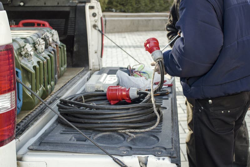 Worker Near Car with Power Extander Electrical Plug for Construction ...