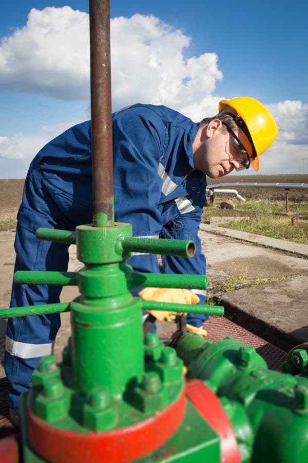 Worker on the oil field stock photo. Image of energy - 52411356