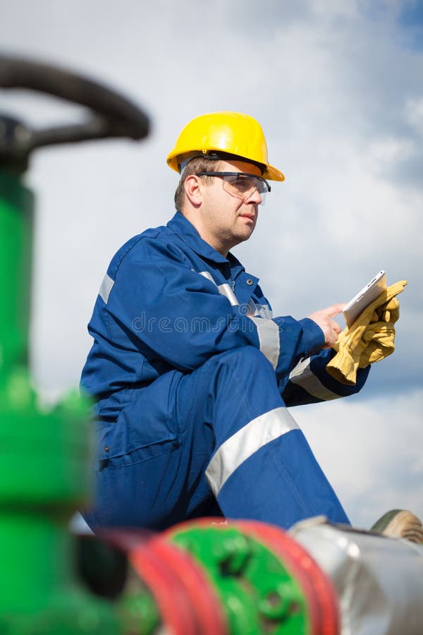 Worker on the oil field stock image. Image of industrial - 52412225