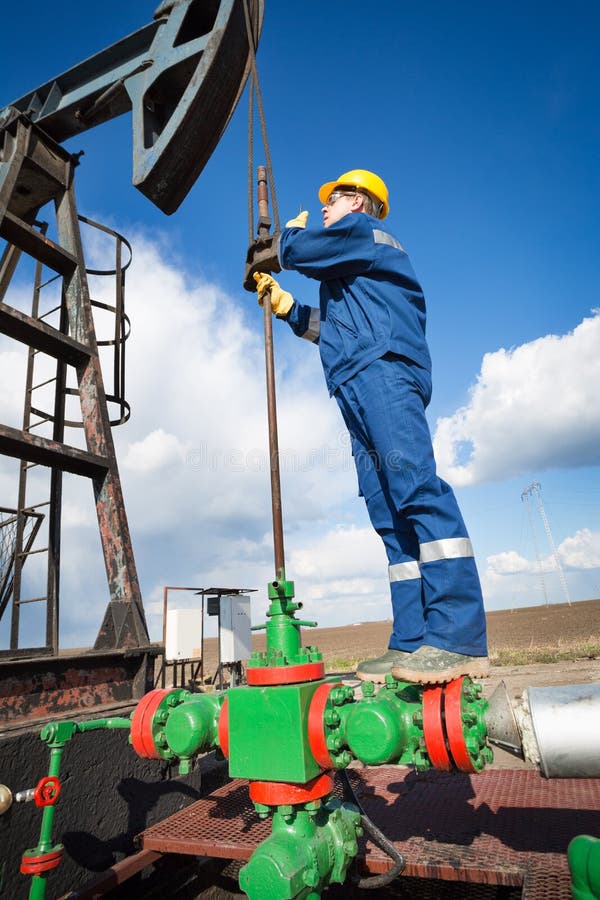 Worker on the oil field stock photo. Image of energy - 52411356