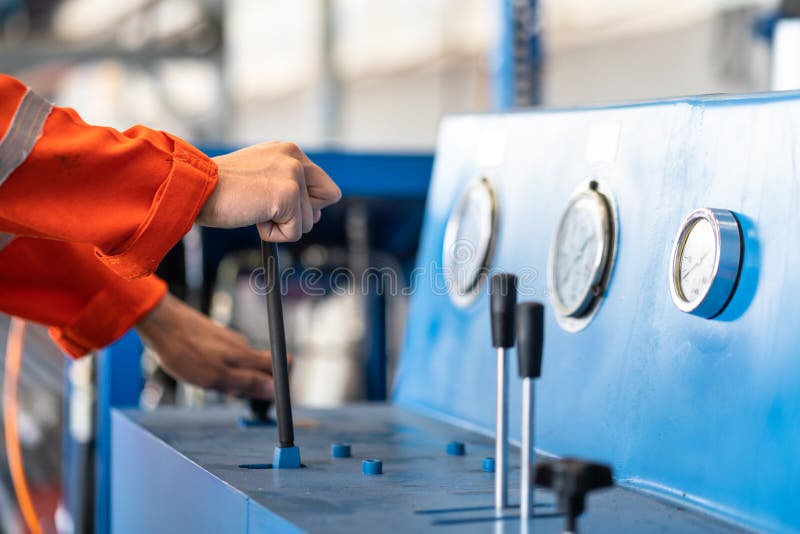 A Worker is Operate and Control the Machine. Stock Photo - Image of ...