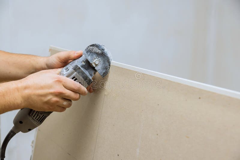 Hands are Using a Tool To Smooth the Edge of Drywall in a Construction ...