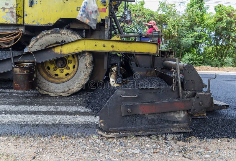 Worker Operating Industrial Asphalt Paver Machine during Highway ...