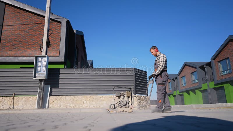 Worker Operating Plate Compactor on Paved Street Stock Footage - Video ...