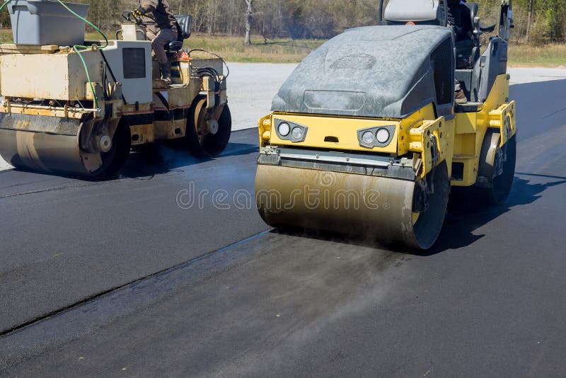 Worker Operating a Vibratory Road Roller Compactor Process Machine ...