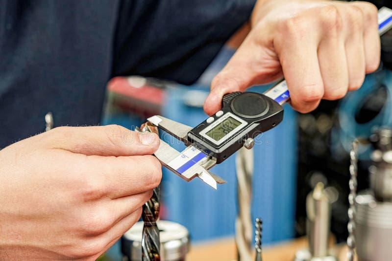 The Worker Operator of the Cnc Machine Tool Measures the Cutting Tool ...
