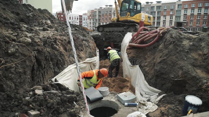 Worker in Orange Hard Hat Digging Sand Concrete Chamber Manhole Ring in ...