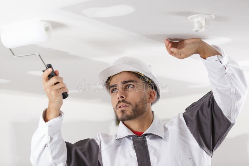 Worker in painting ceiling stock image. Image of caucasian - 233684063