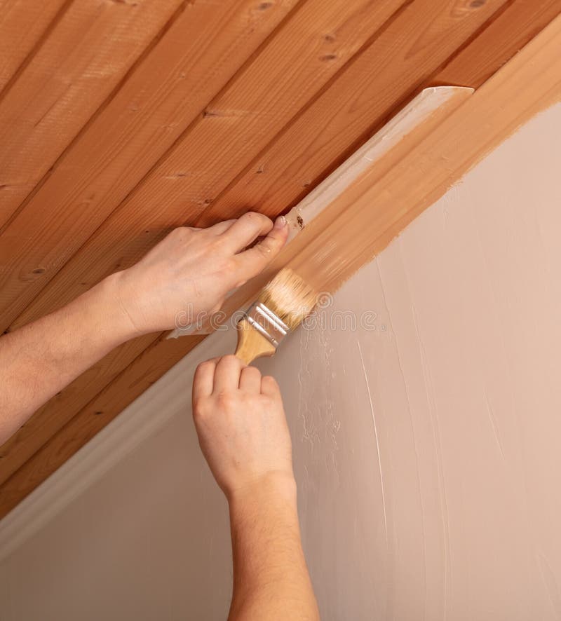 A Worker Paints Moldings on the Ceiling with a Brush. Home Renovation ...