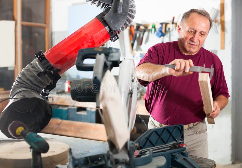 Worker Performs Measurements on Wooden Workpiece with Caliper. Working ...