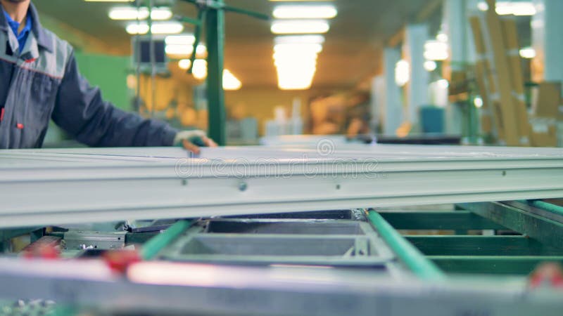 A Worker Loads a PVC Window Frame on an Assembly Table. Stock Footage ...