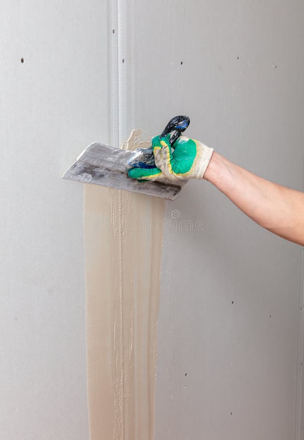 A Worker is Plastering a Wall with a Plastering Tool. Stock Photo ...