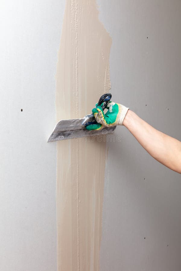 A Worker is Plastering a Wall with a Plastering Tool. Stock Photo ...