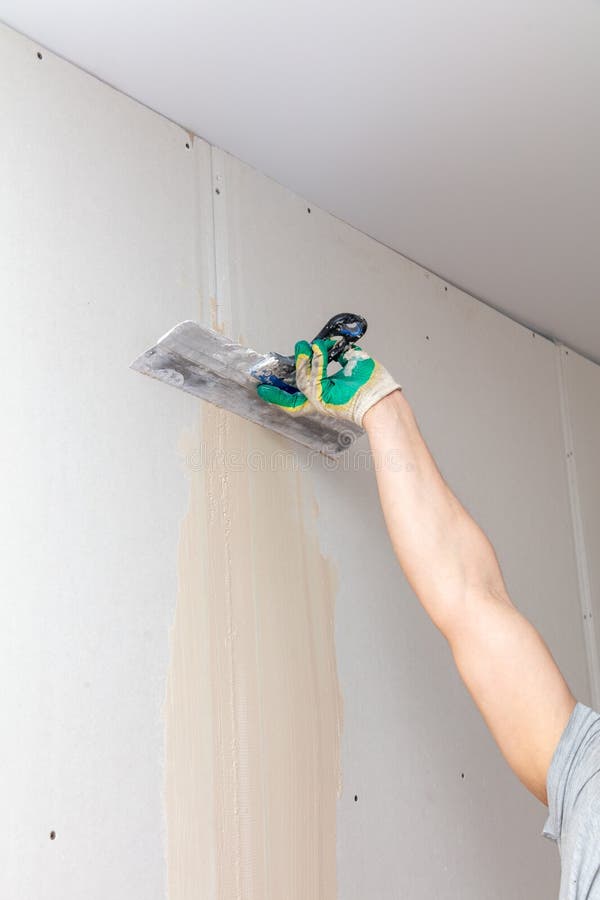 A Worker is Plastering a Wall with a Plastering Tool. Stock Image ...