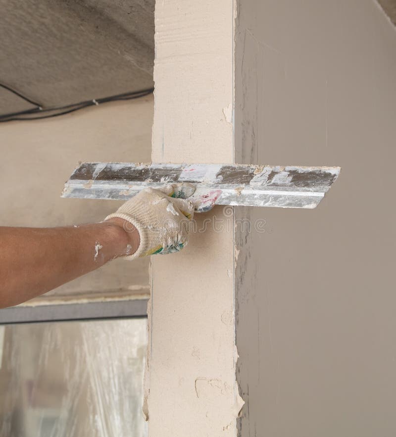 A Worker is Plastering the Walls of a House Under Construction Stock ...