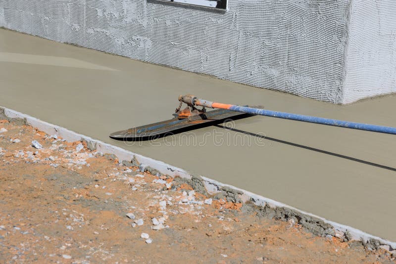 Worker Plasters a Wet Concrete Floor Using a Trowel after Pouring ...