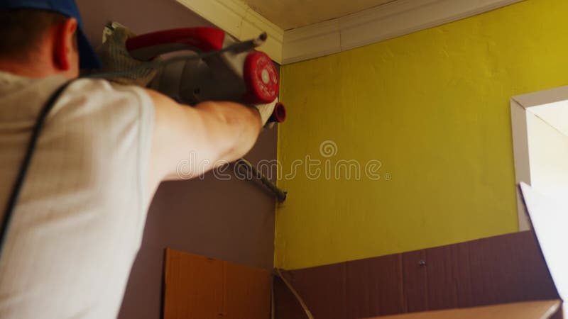 Man Pneumatic Hammer Drill a Hole in the Wall. a Worker Using an ...